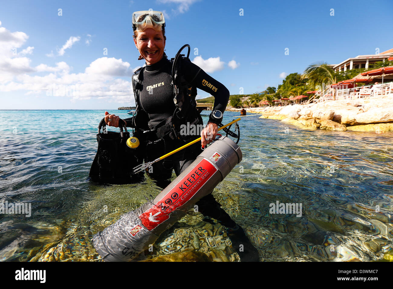 Diver holds a Zoo Keeper, a device for catching the invase Lionfish in ...