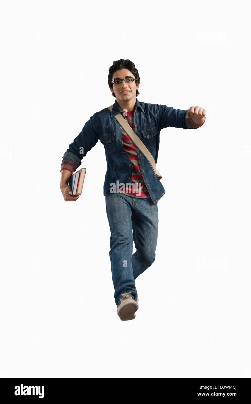 University student running with books and bag Stock Photo - Alamy