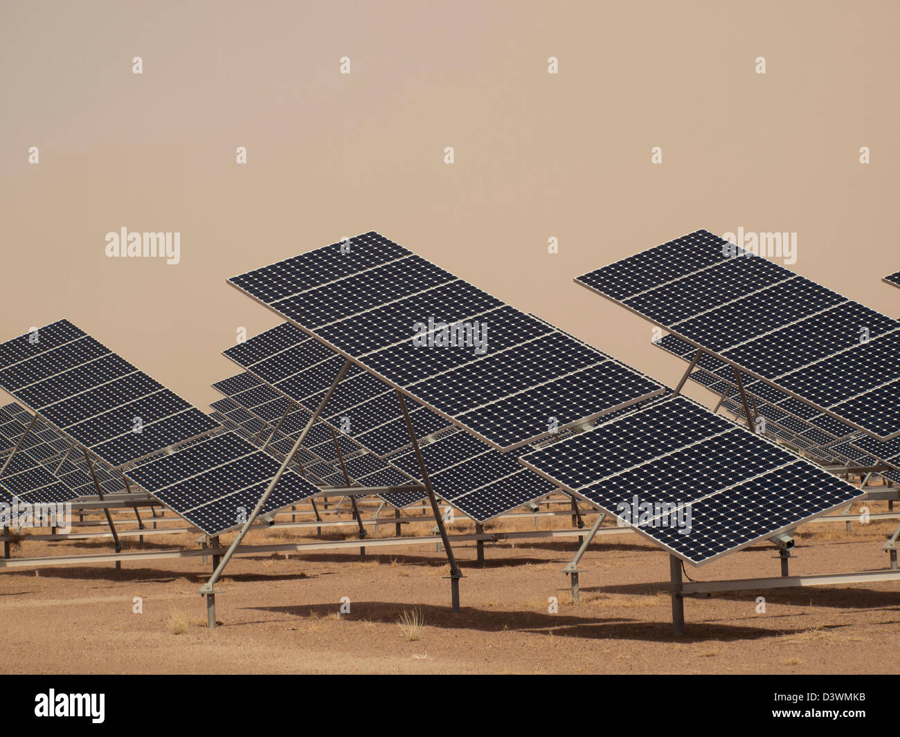 A series of large solar panels forms a symmetrical line at a power ...