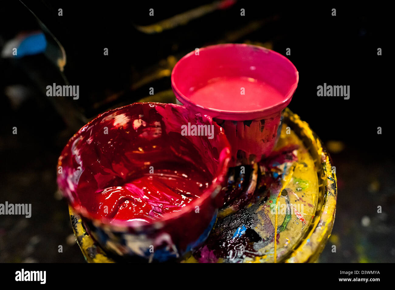 Buckets of red printing ink seen in the print shop in Cali, Colombia ...