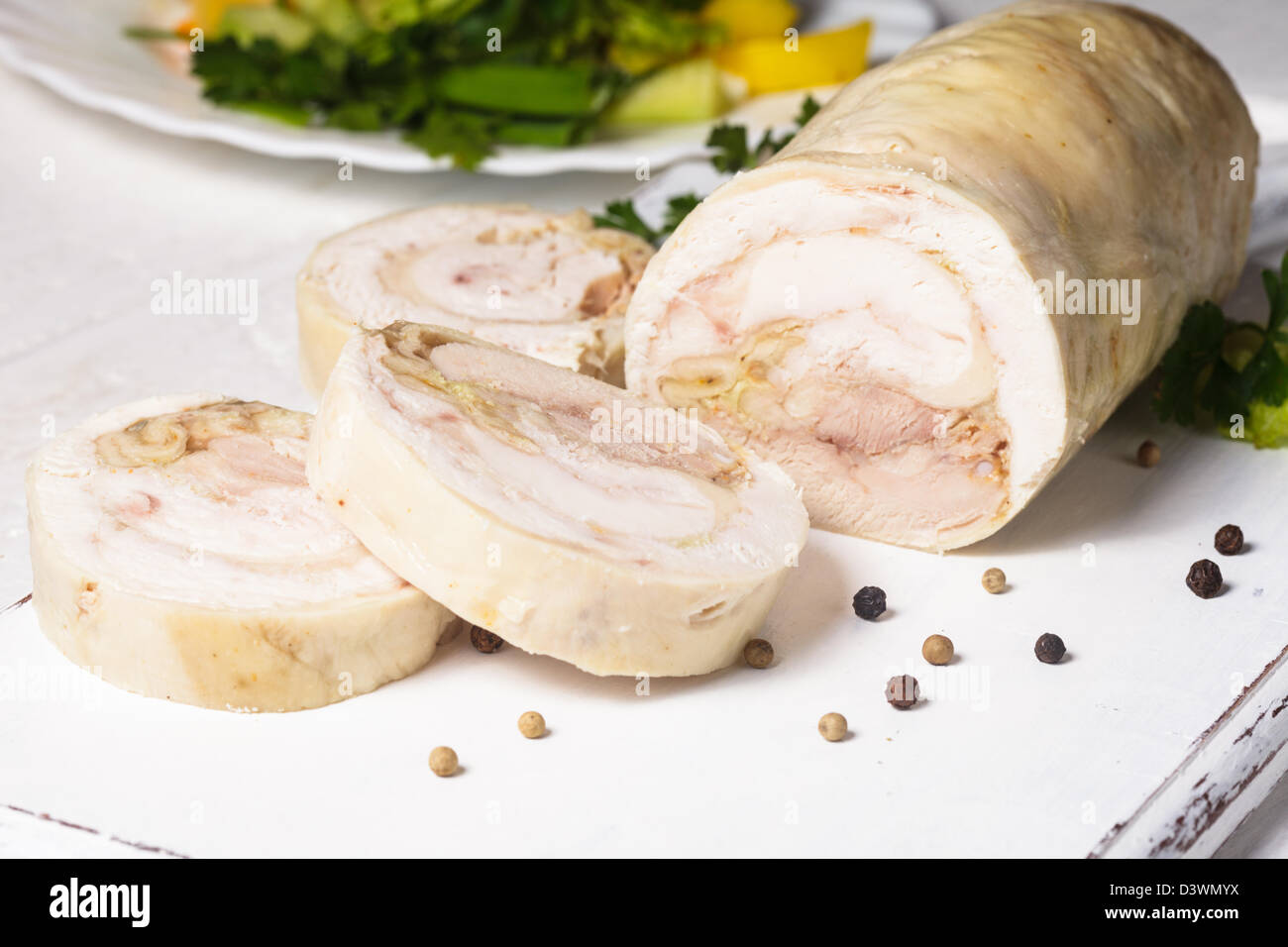 A baked chicken roll on the white cutting board Stock Photo - Alamy