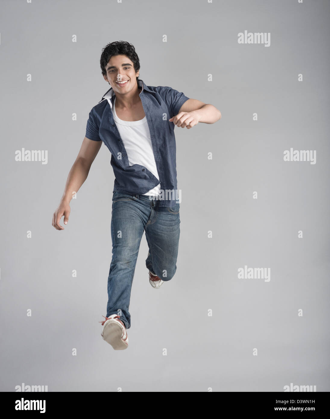 Smiling indian man running studio hi-res stock photography and images ...
