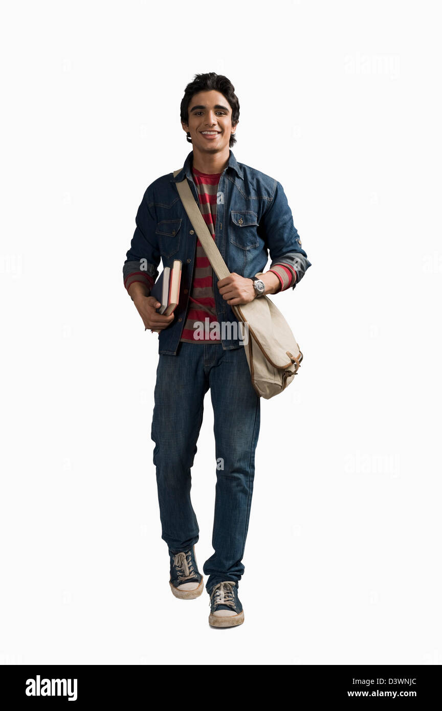 University student walking with books and bag Stock Photo - Alamy