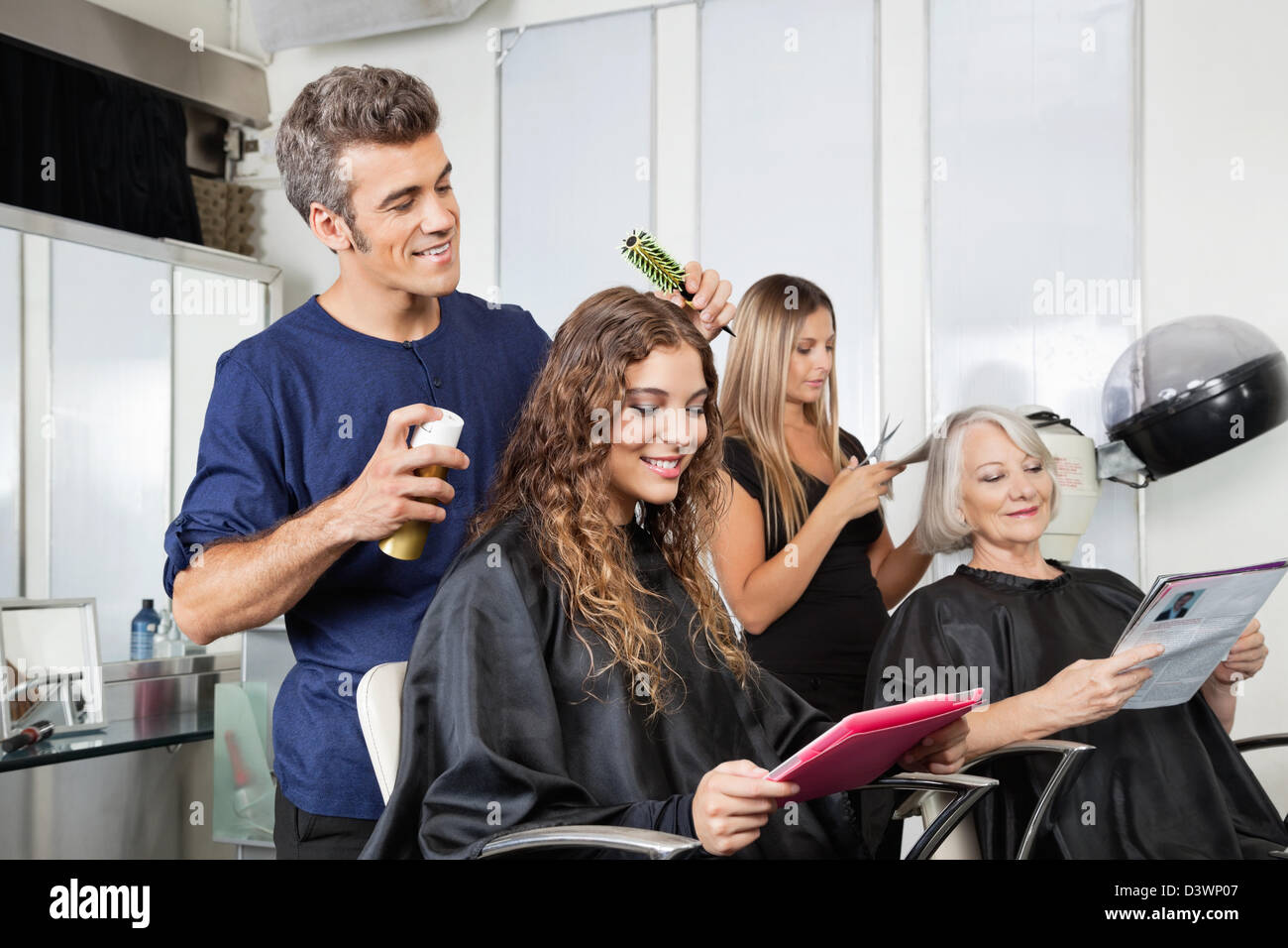 Hairdressers Setting Up Client's Hair In Salon Stock Photo - Alamy