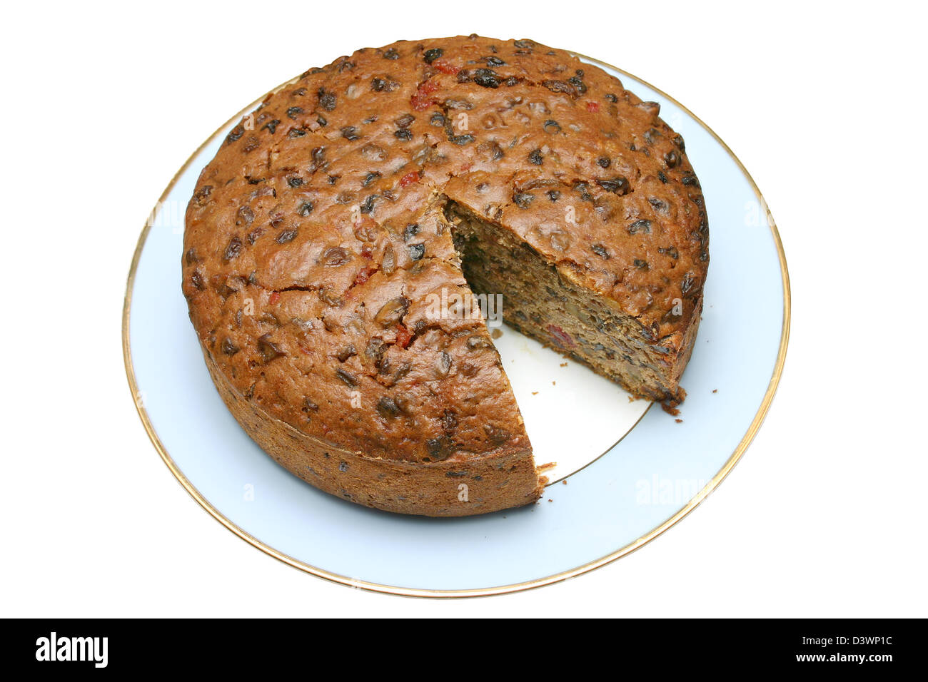 Home made fruit cake with a slice missing, isolated on a white ...