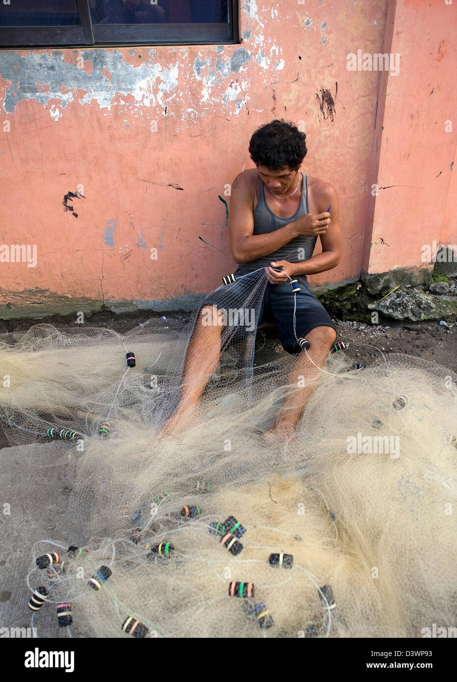 Filipino Man Mending Fishing Net Stock Photo - Alamy