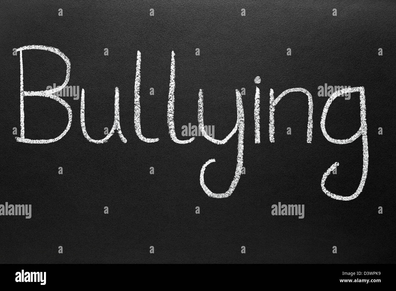 Bullying, written with white chalk on a blackboard Stock Photo - Alamy