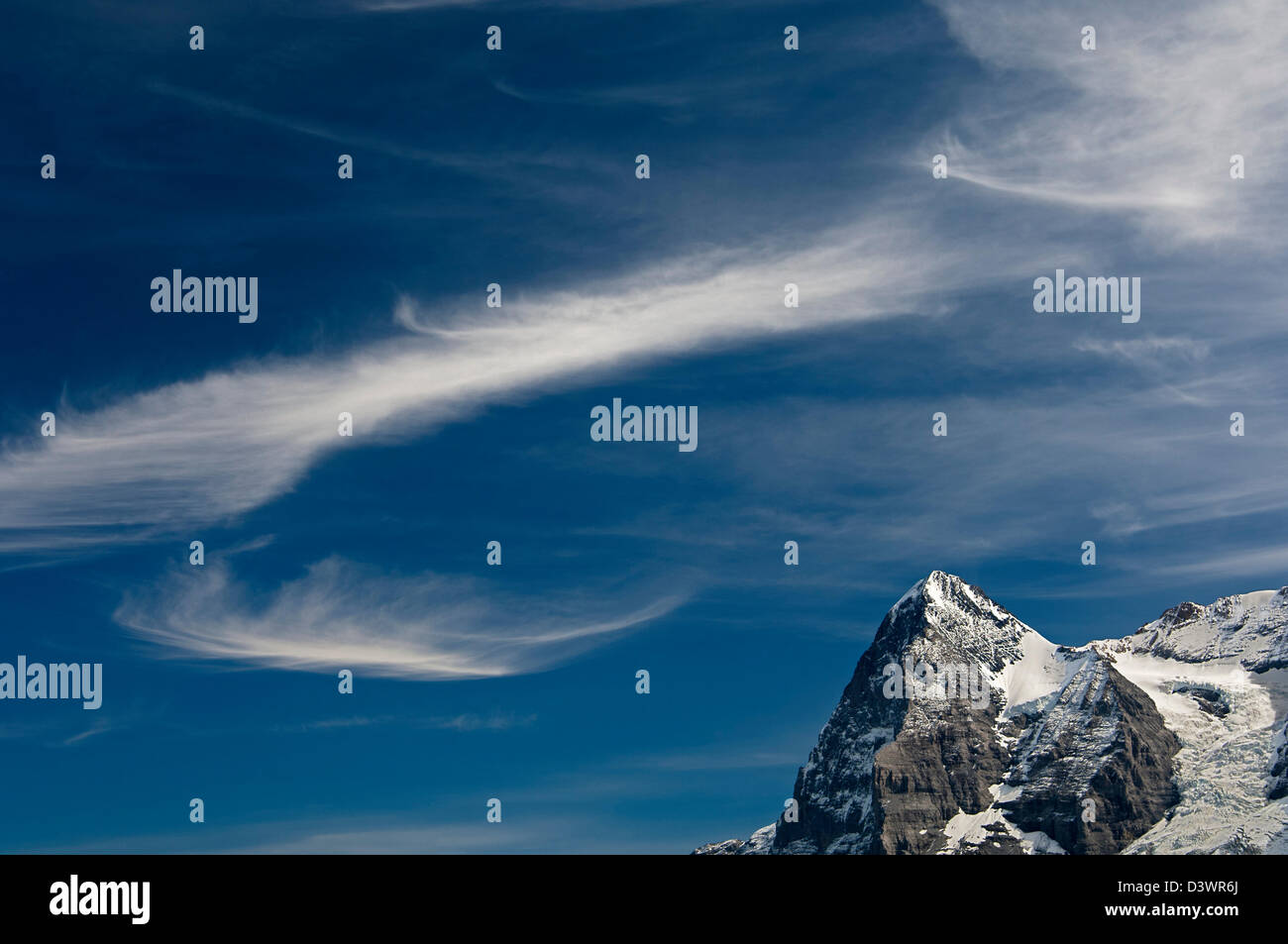 The Eiger summit under a dramatic sky with cirrus clouds, Bernese ...