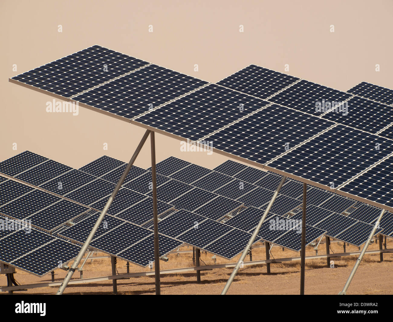 A series of large solar panels forms a symmetrical line at a power ...