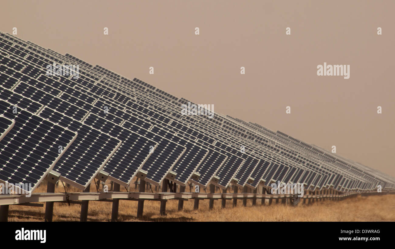 A series of large solar panels forms a symmetrical line at a power ...