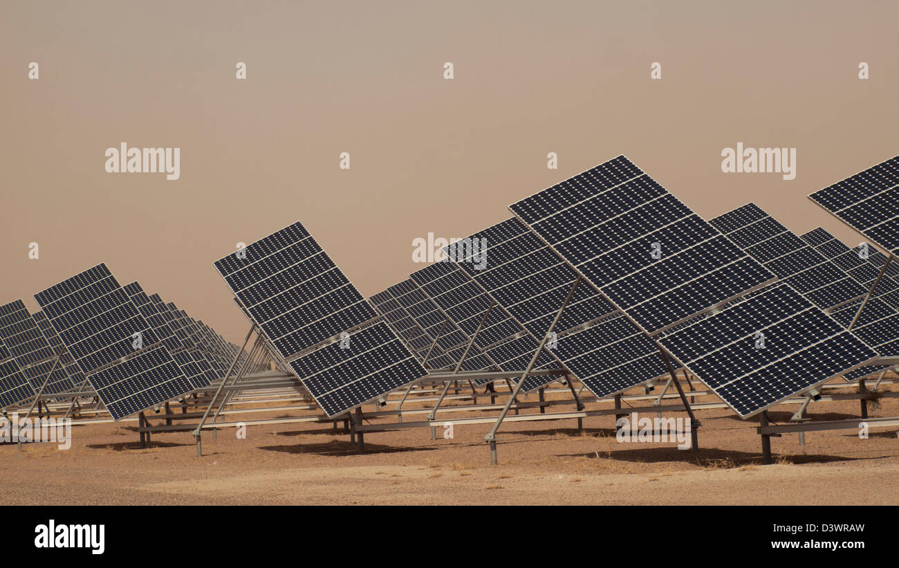 A series of large solar panels forms a symmetrical line at a power ...