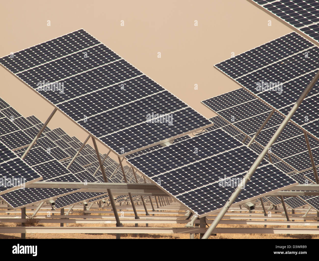 A series of large solar panels forms a symmetrical line at a power ...