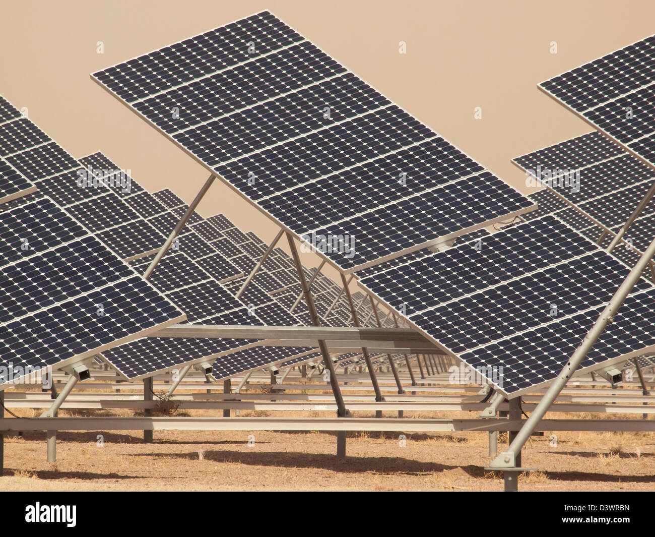 A series of large solar panels forms a symmetrical line at a power ...