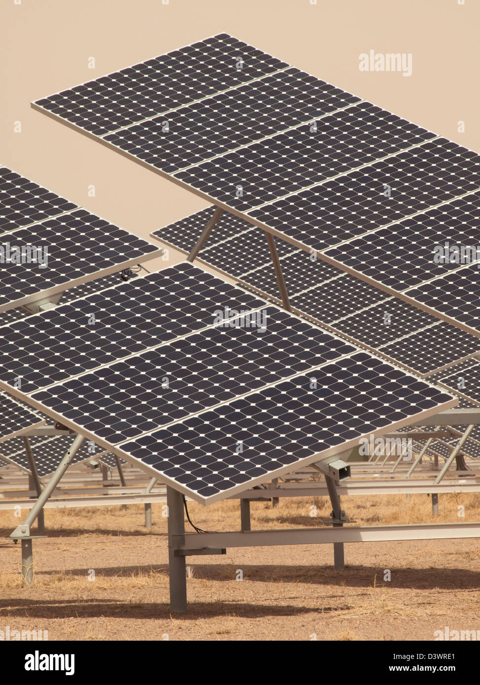 A series of large solar panels forms a symmetrical line at a power ...