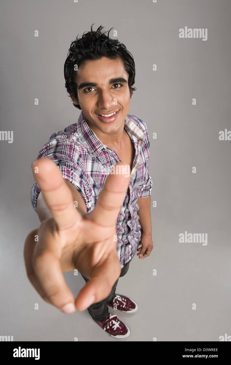 Man showing victory sign Stock Photo - Alamy