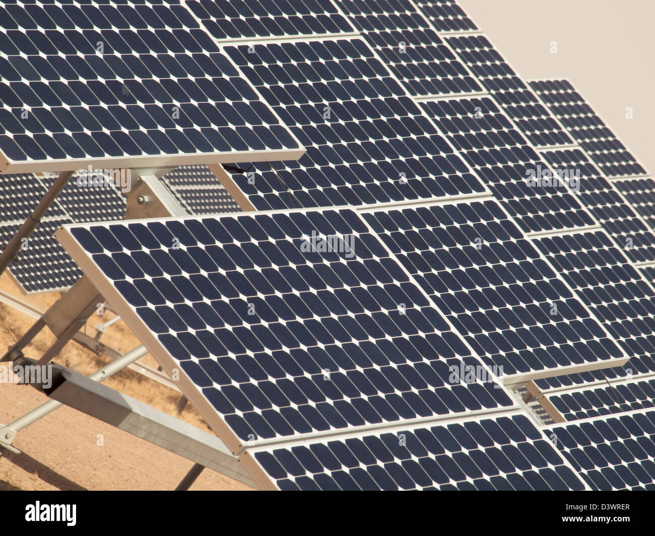 A series of large solar panels forms a symmetrical line at a power ...