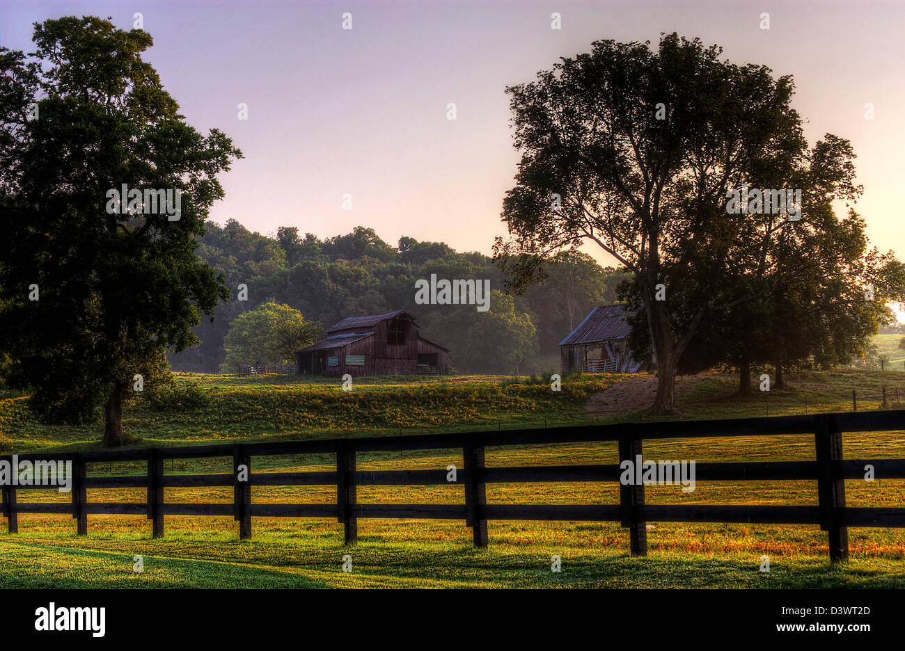A beautiful rural scene, a barn and fence early in the morning Stock ...