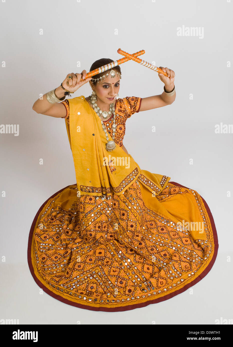 Woman performing dandiya Stock Photo - Alamy