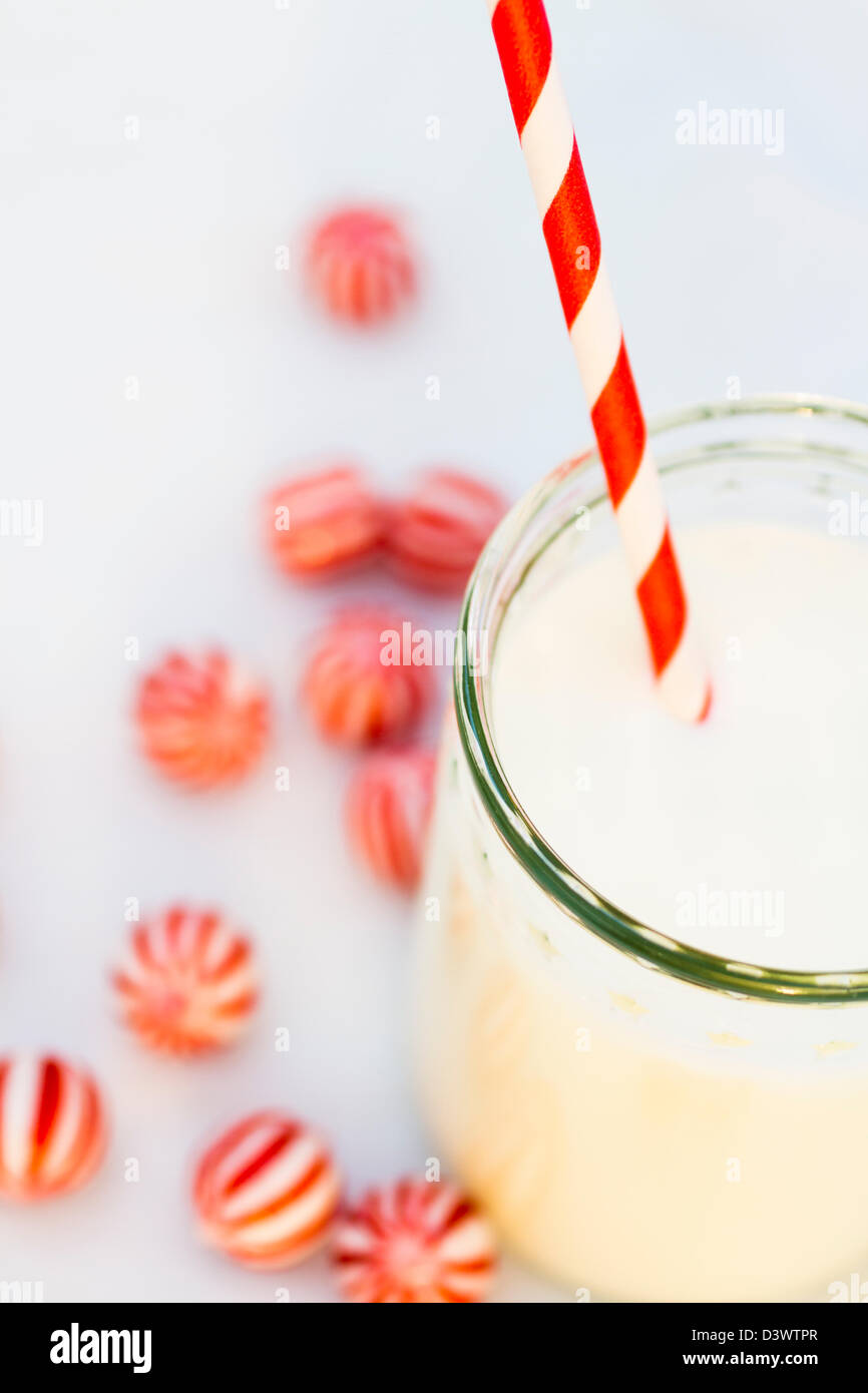 Glass of milk in a jar with a red straw Stock Photo - Alamy