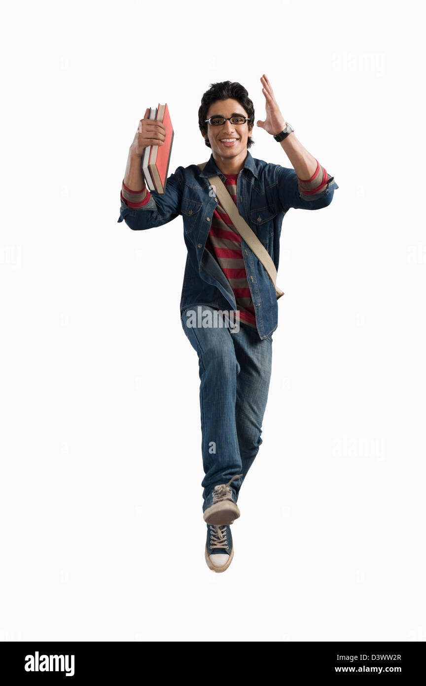 University student running with books and bag Stock Photo - Alamy