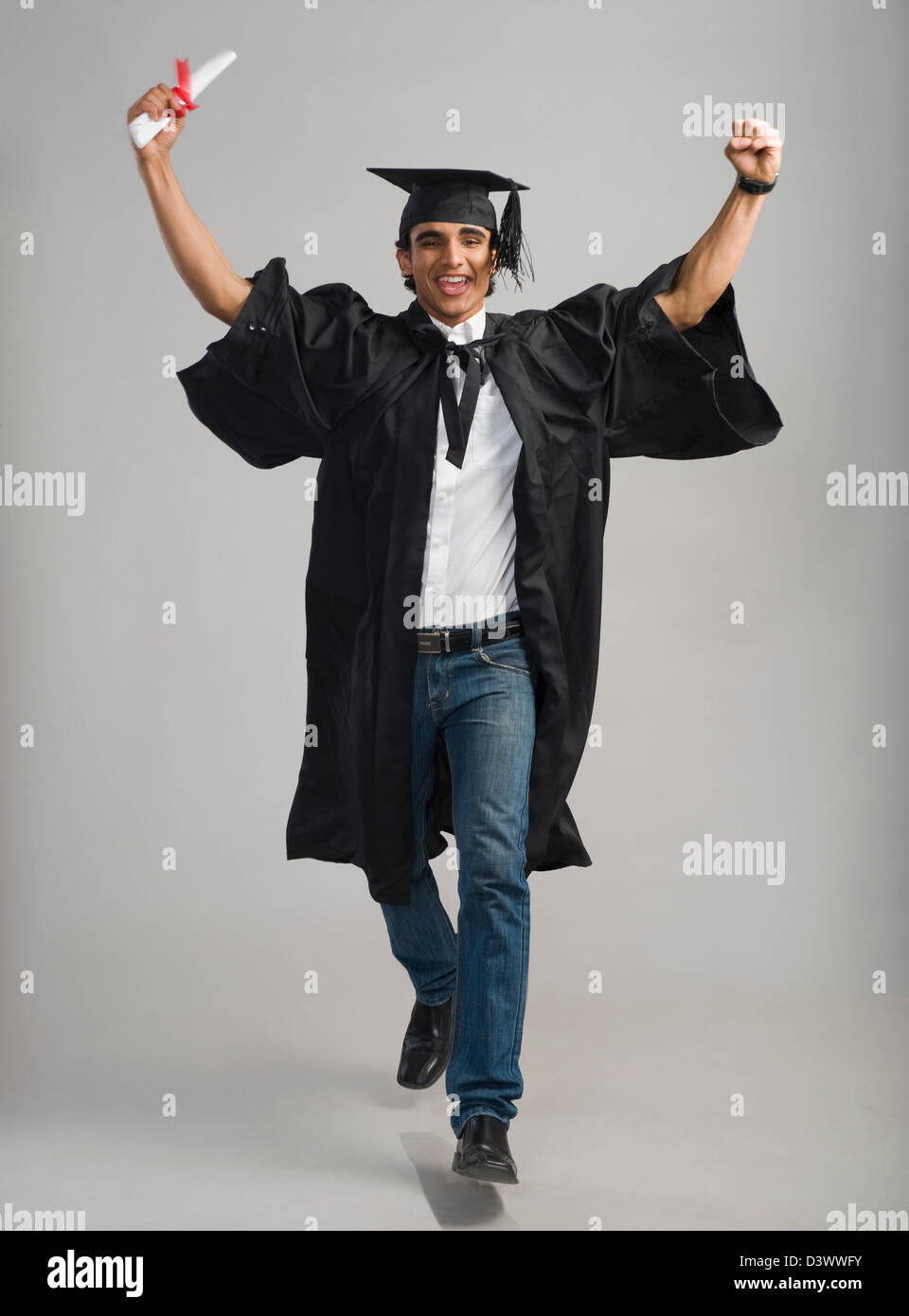 Male graduate cheering with his diploma Stock Photo - Alamy
