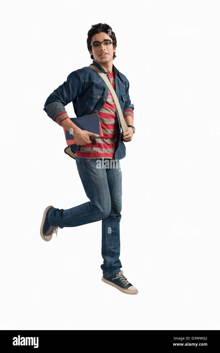 University student running with books and bag Stock Photo - Alamy