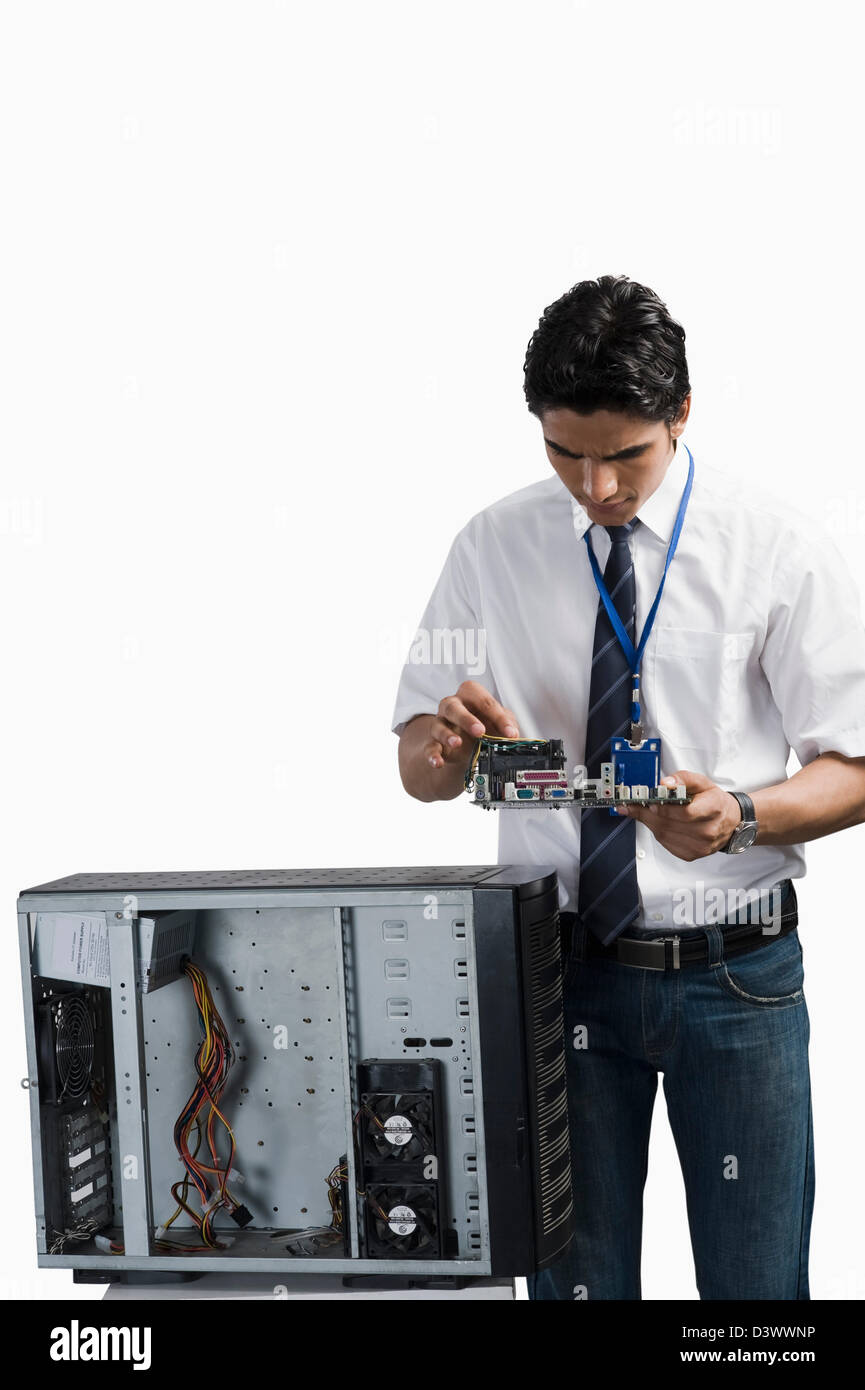 Engineering student examining a computer board before assembling Stock ...
