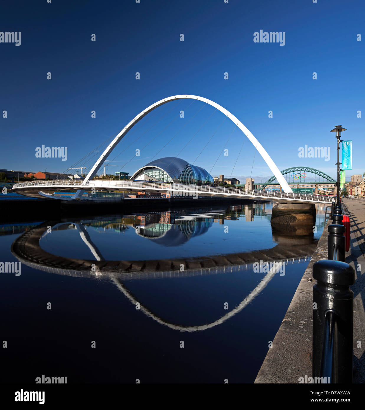 A sunny daytime view in summer of Gateshead Millennium bridge reflected ...