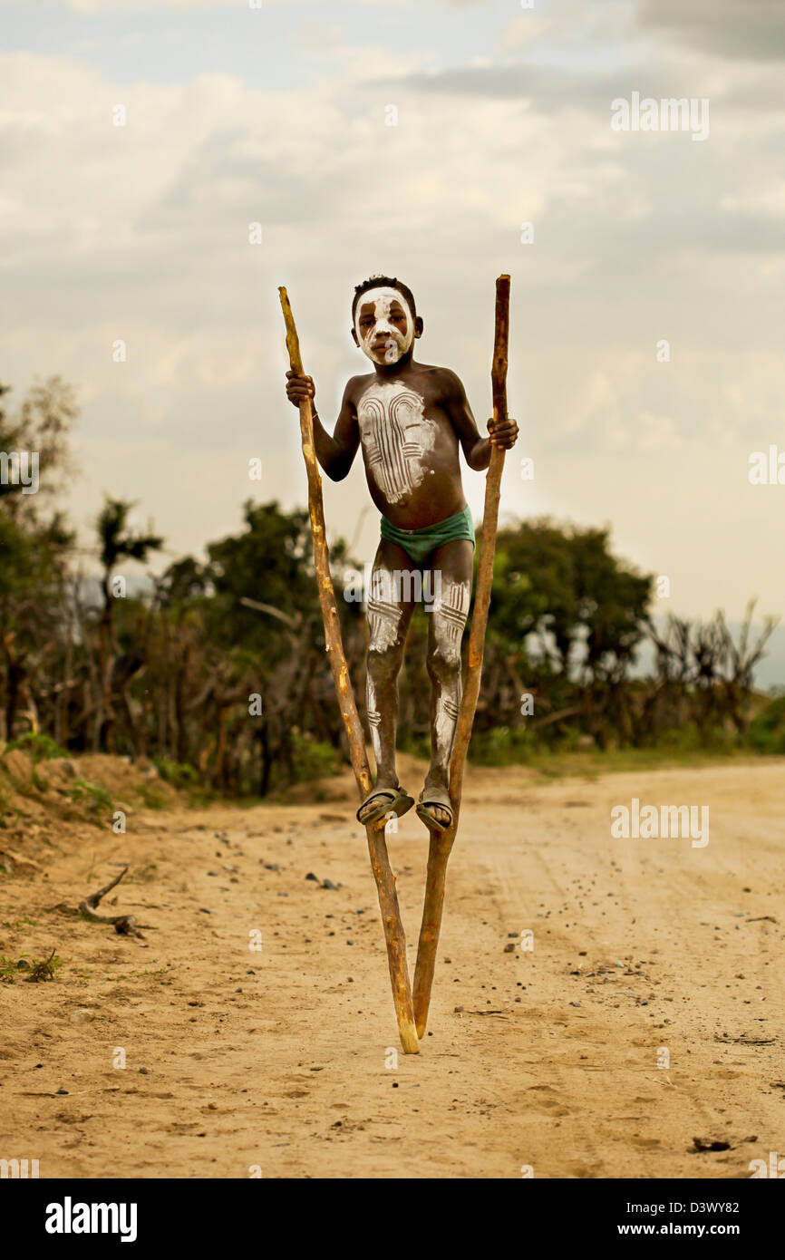 Boy on the stilts - Africa, Ethiopia Stock Photo - Alamy