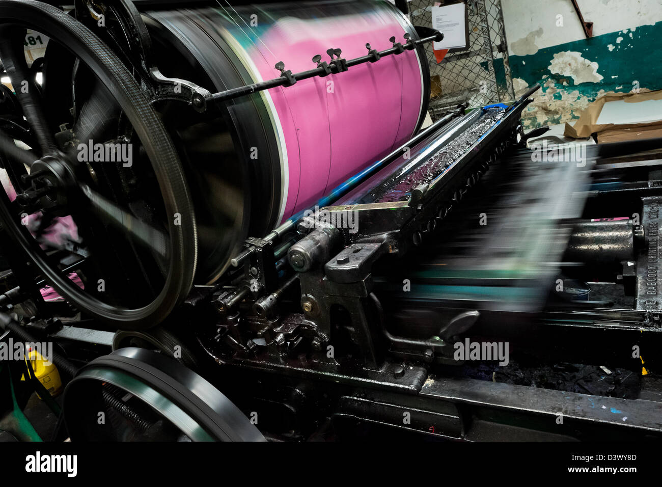 An ancient letterpress machine seen during the running in the print ...