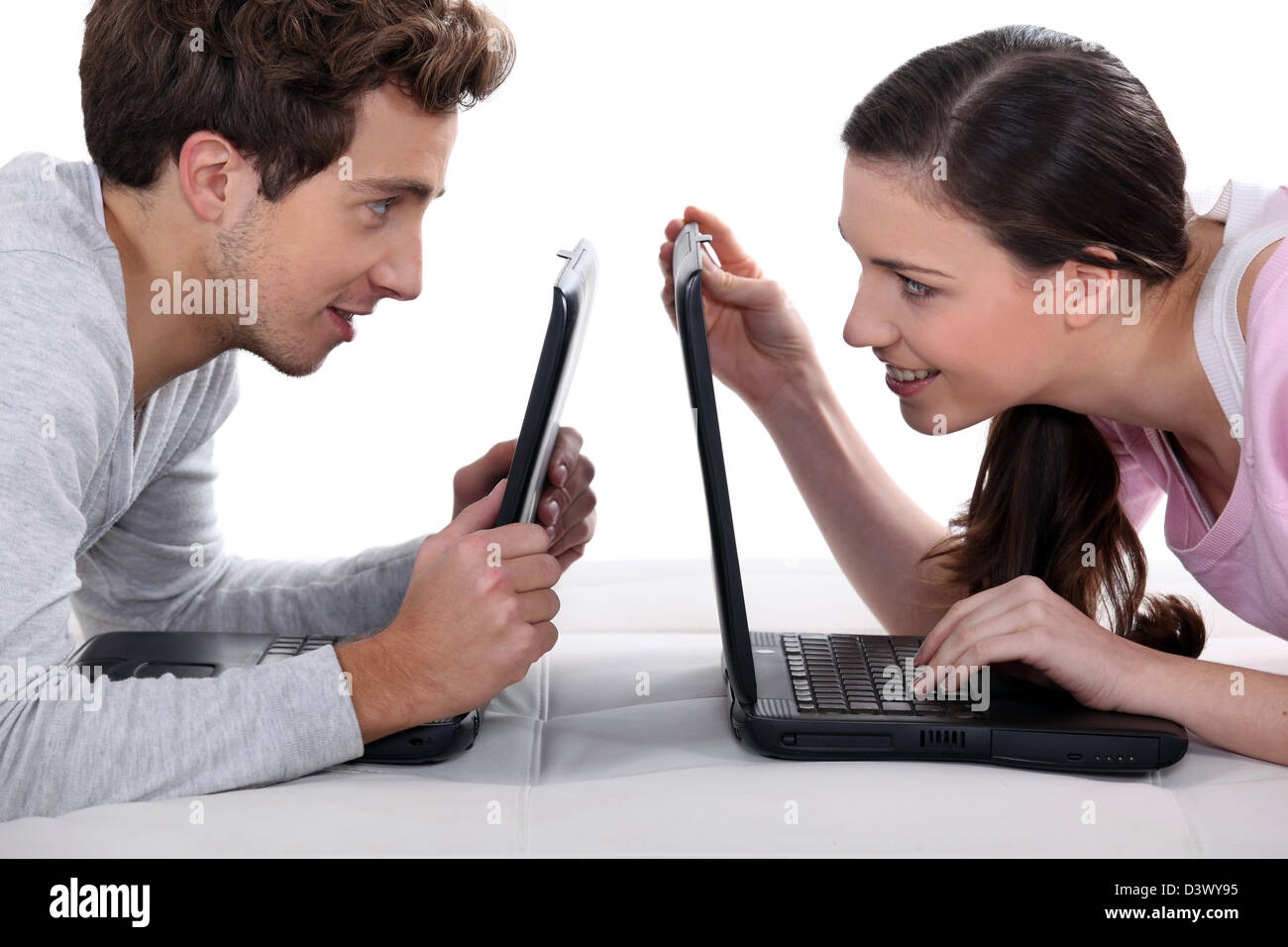 Couple looking over the computer Stock Photo - Alamy