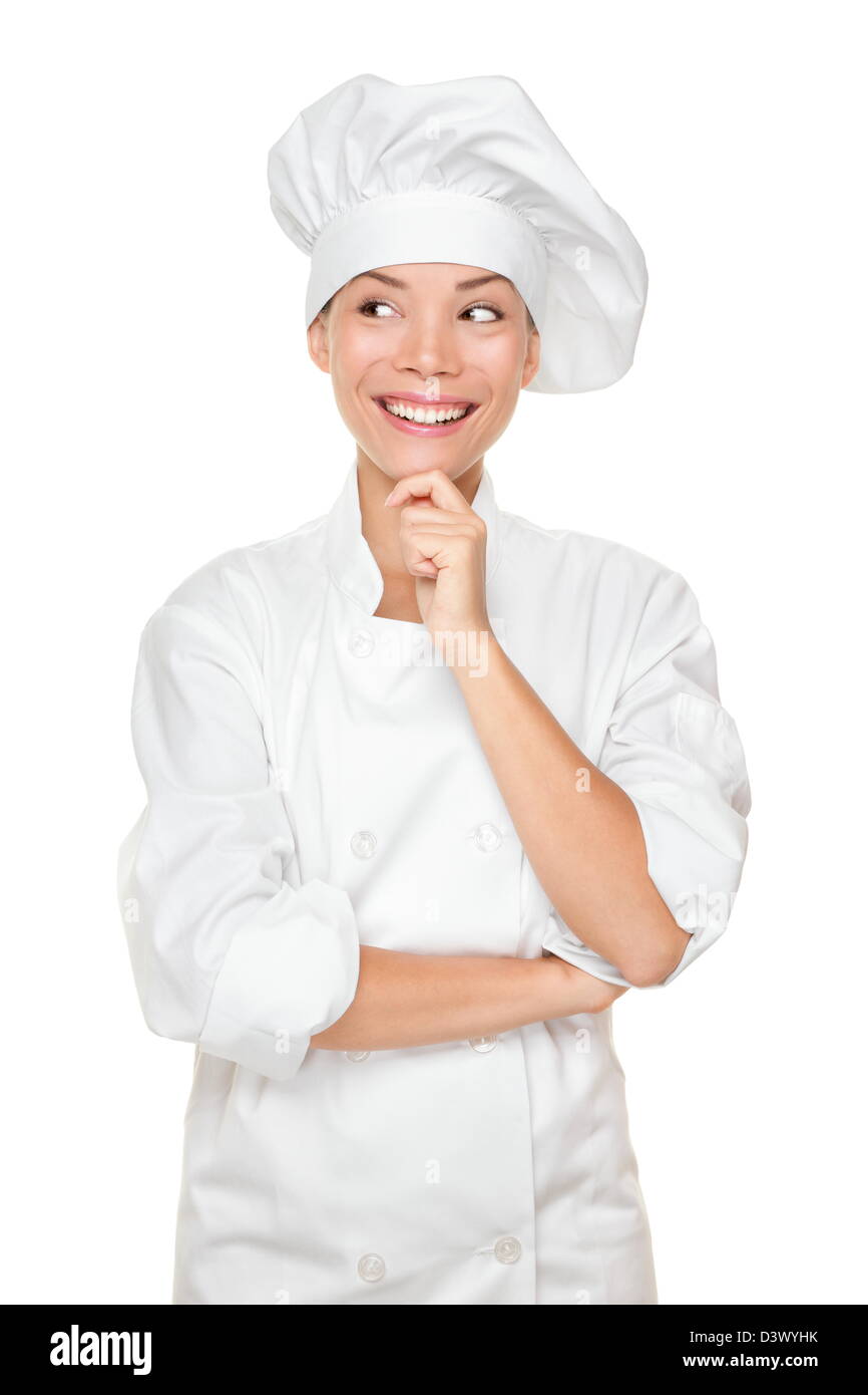 Young smiling Asian female chef thinking looking to the side isolated ...