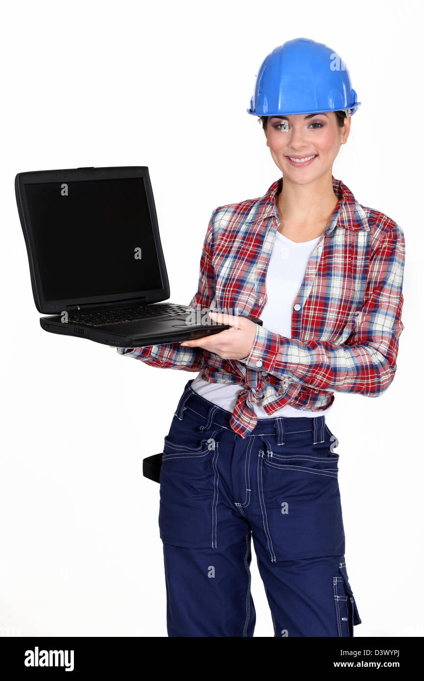 Female manual worker showing off laptop Stock Photo - Alamy