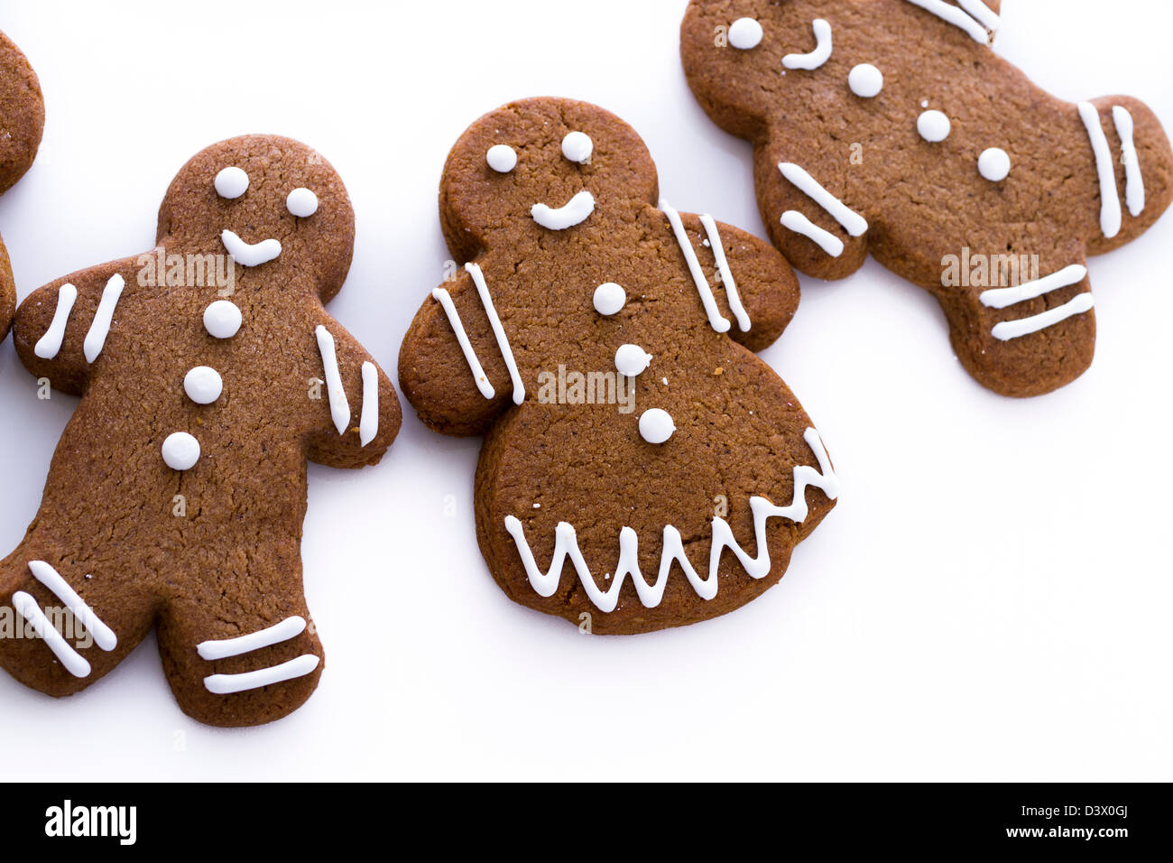 Homemade gingerbread cookies decorated with white icing on white ...