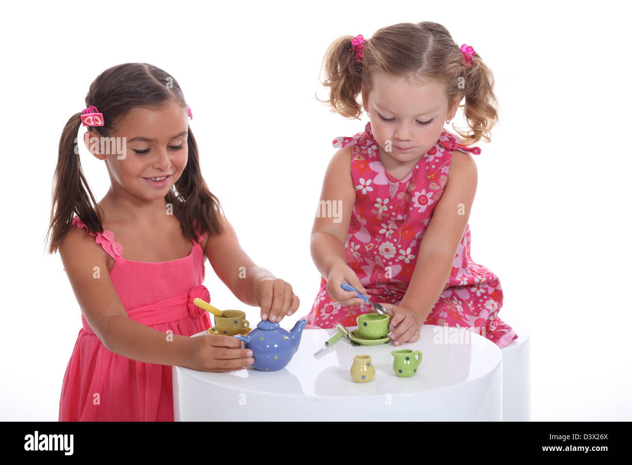 Little girls playing, studio shot Stock Photo - Alamy