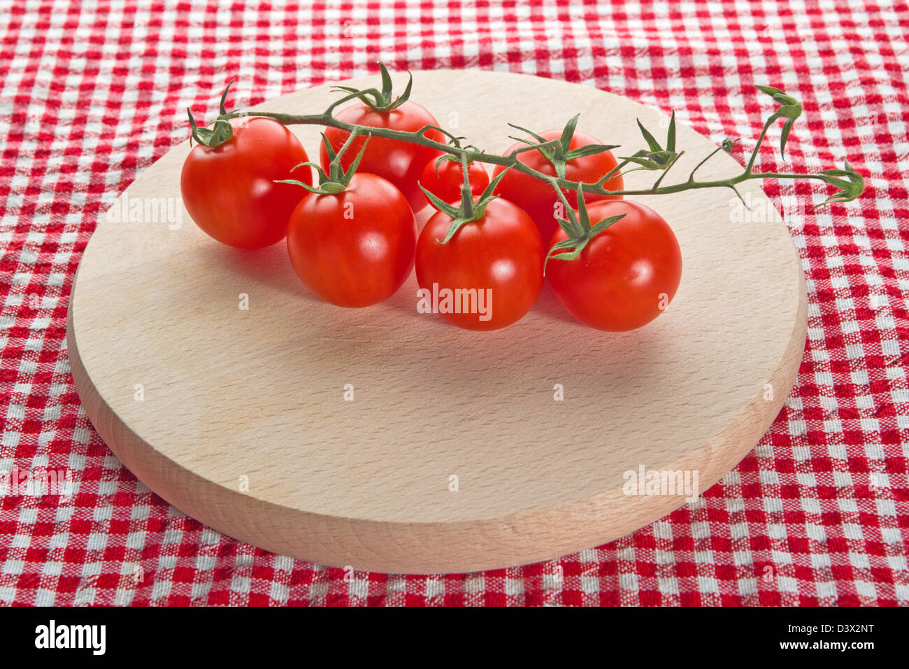 Fresh, ripe cherry tomatoes on wood chopping board Stock Photo - Alamy