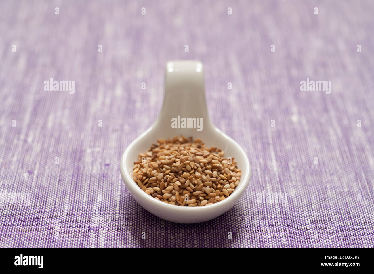 Close up view of organic Red Sesame Seeds in a ceramic spoon Stock ...