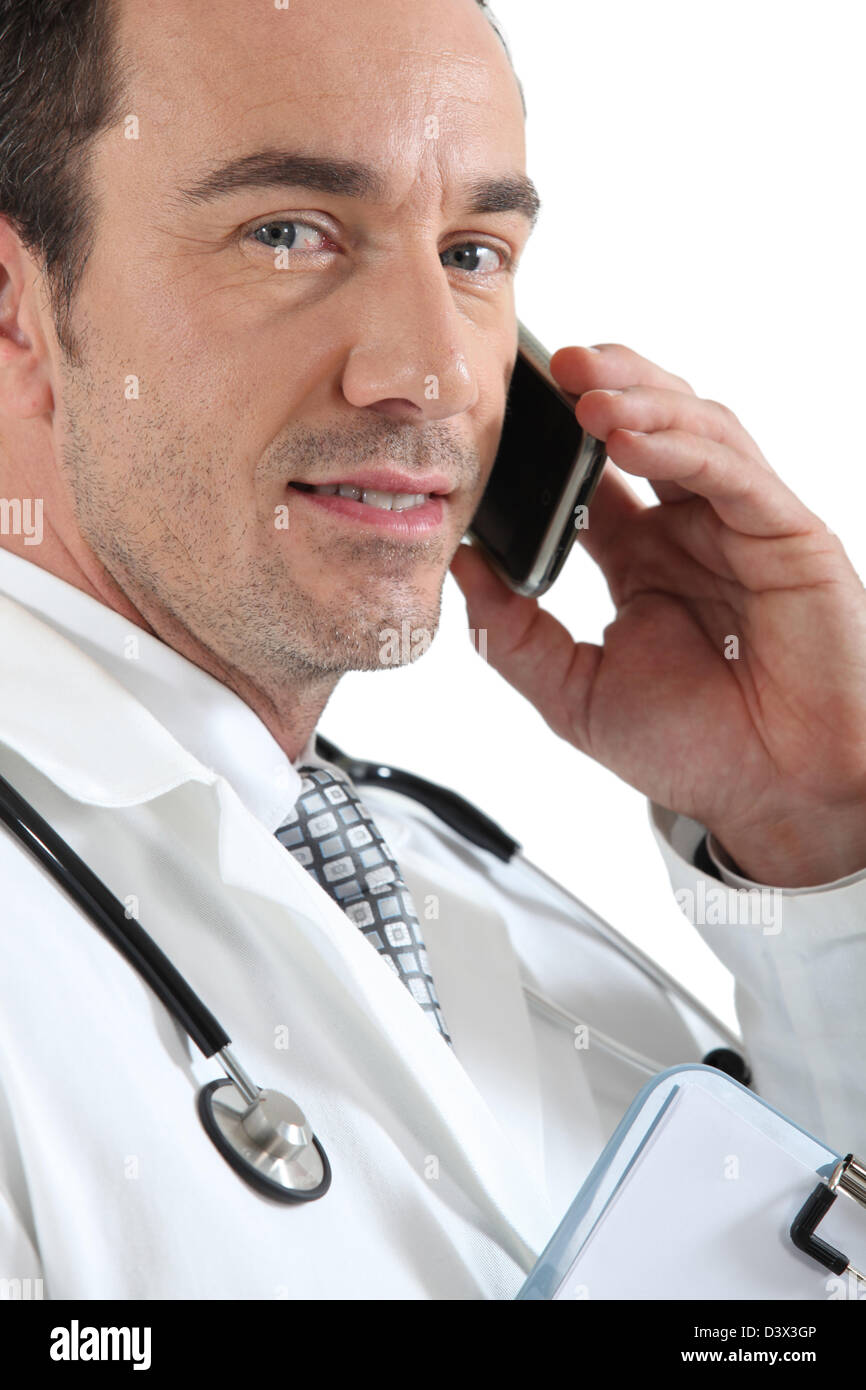Doctor on phone smiling Stock Photo - Alamy