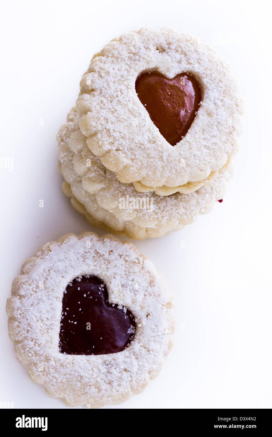 Linzer Torte cookies on white background with powdered sugar sprinkled ...