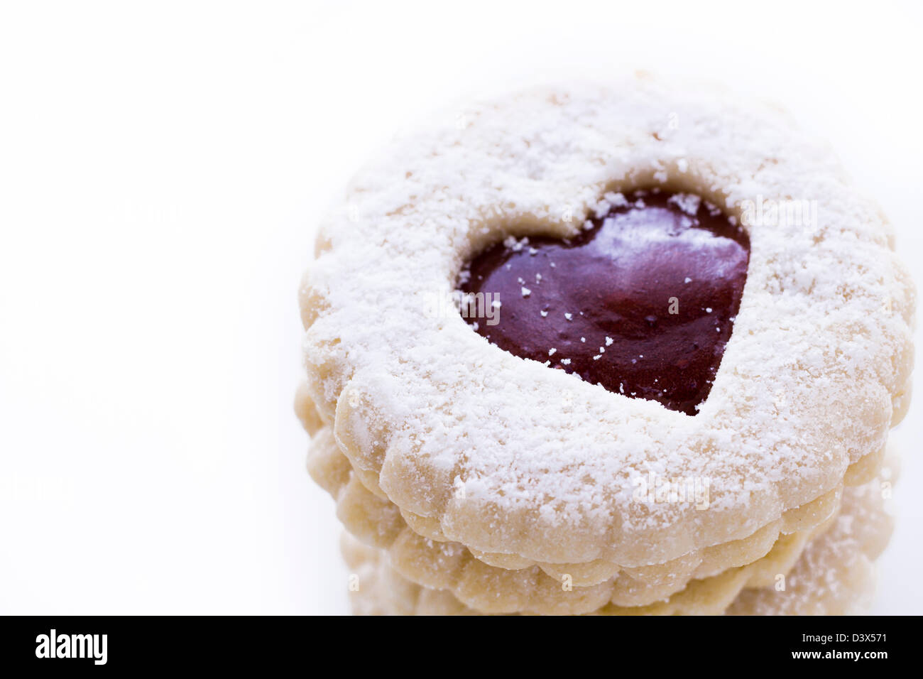 Linzer Torte cookies on white background with powdered sugar sprinkled ...