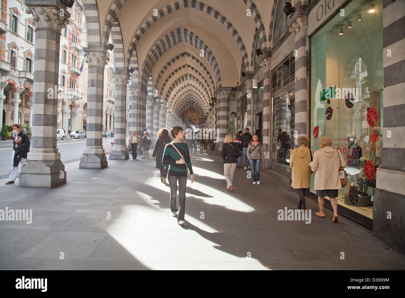 Genoa,Italy, and shoppers stroll through the portico,s of the shopping ...