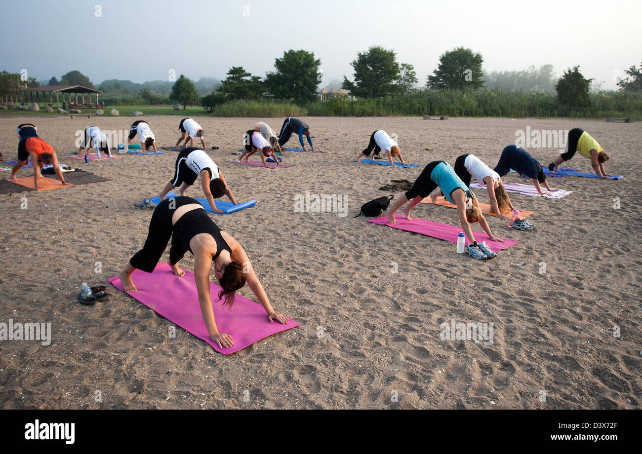 Woman performing yoga in beach hi-res stock photography and images - Alamy