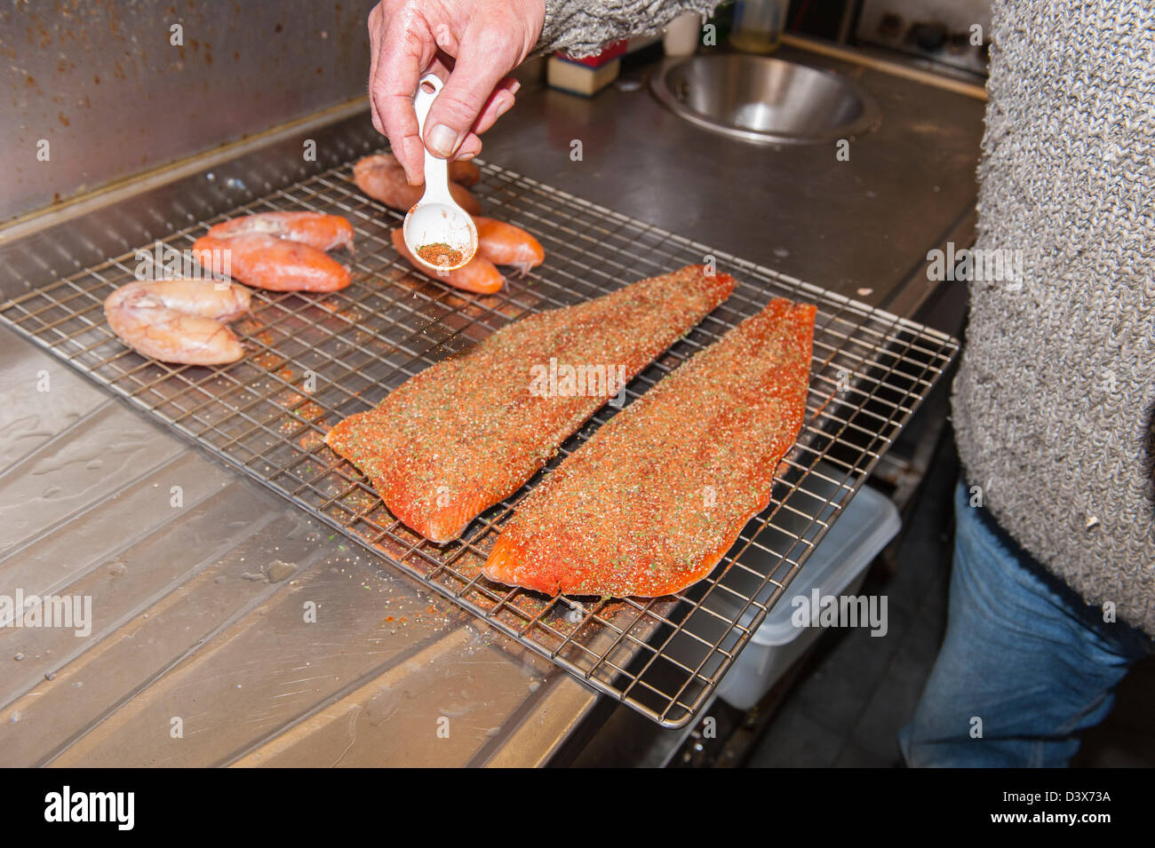Salmon and cod roe being prepared to be smoked at a smoke house in the ...