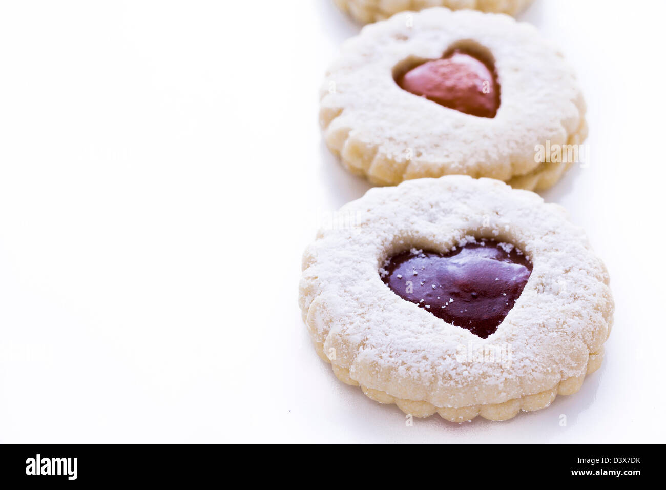 Linzer Torte cookies on white background with powdered sugar sprinkled ...