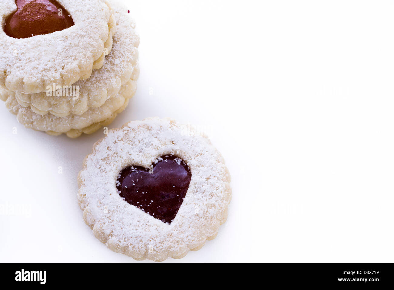 Linzer Torte cookies on white background with powdered sugar sprinkled ...