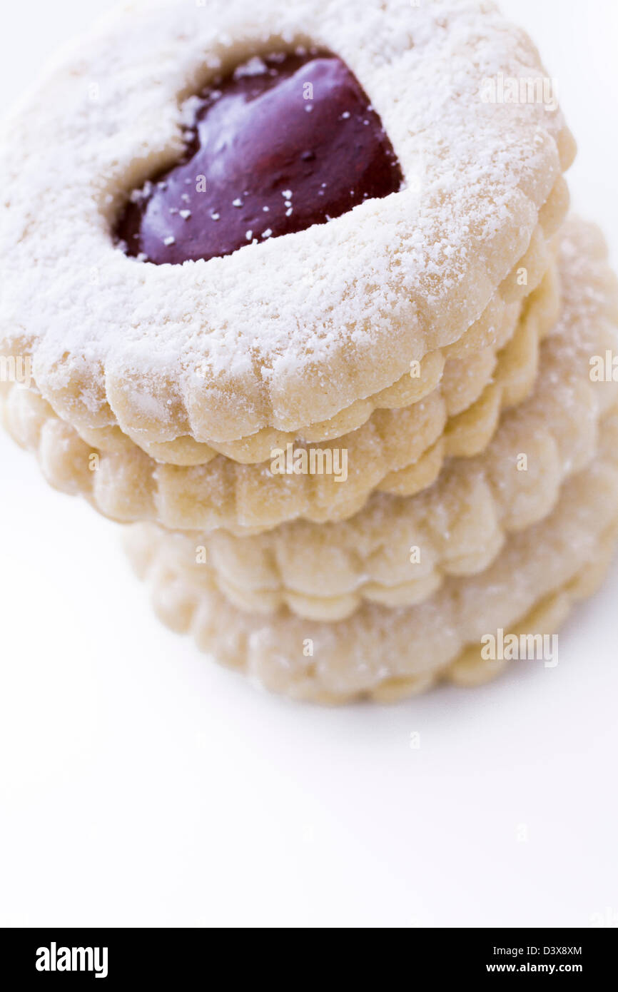 Linzer Torte cookies on white background with powdered sugar sprinkled ...