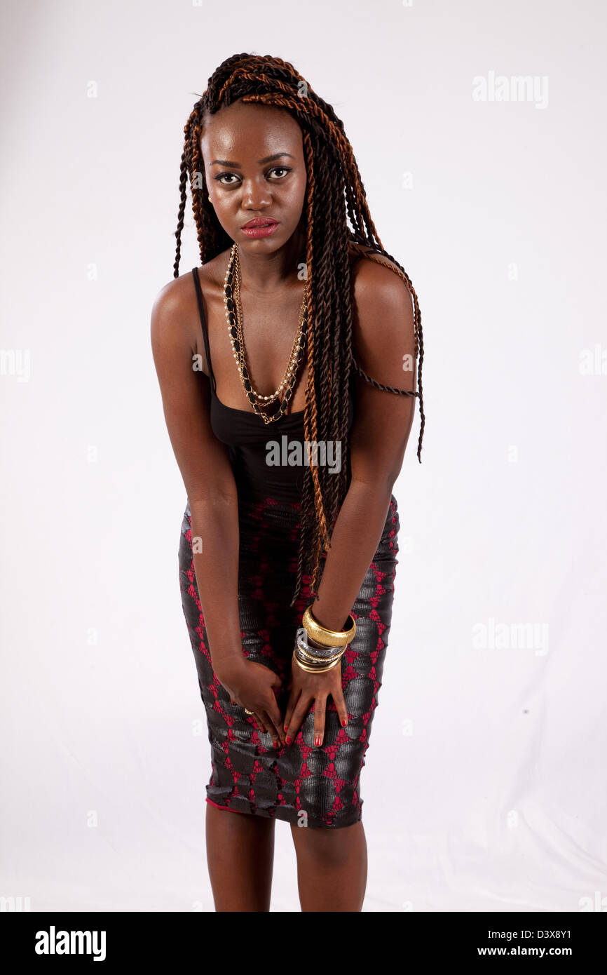 Pretty black woman with long dread locks, looking at the camera with a ...