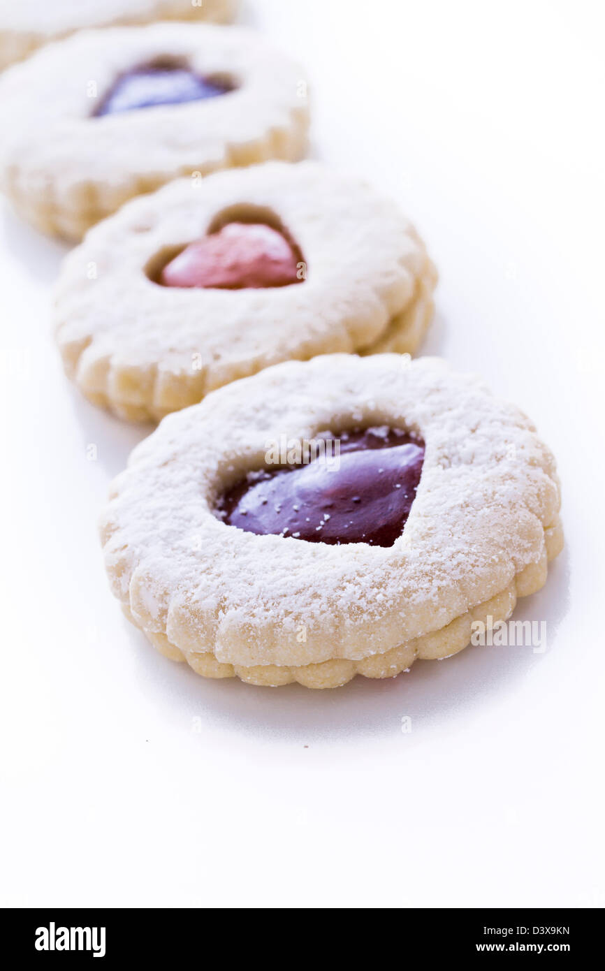 Linzer Torte cookies on white background with powdered sugar sprinkled ...