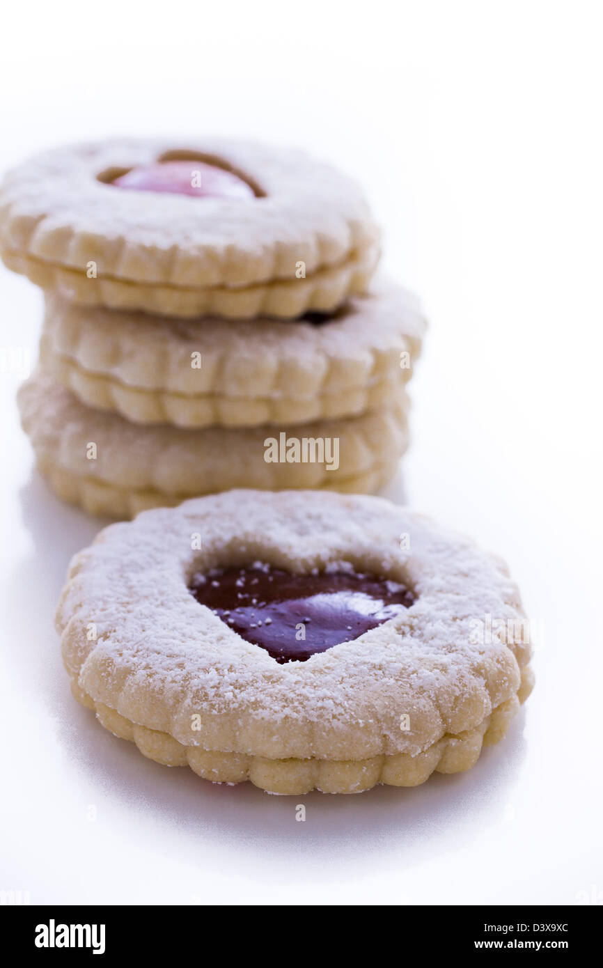 Linzer Torte cookies on white background with powdered sugar sprinkled ...