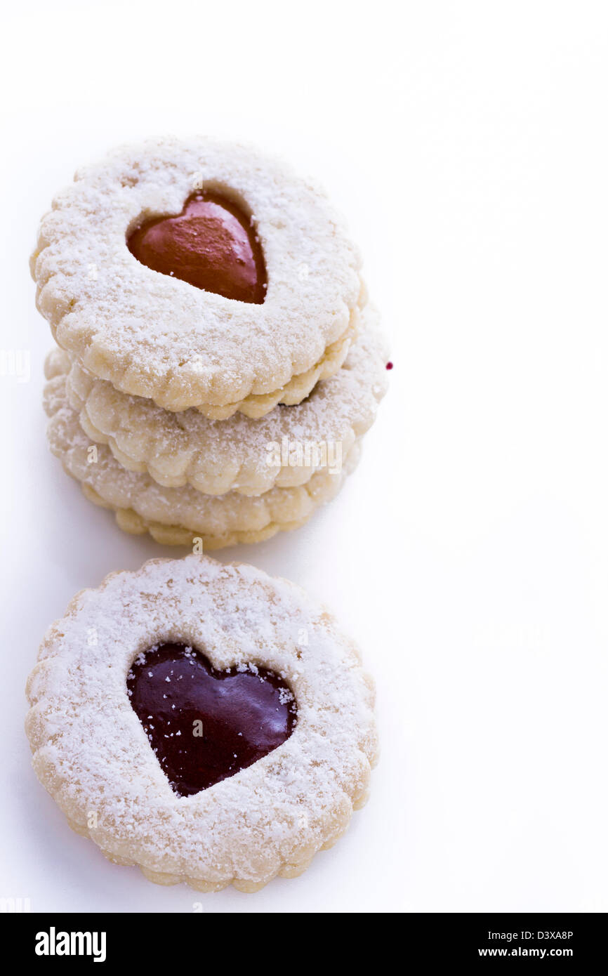 Linzer Torte cookies on white background with powdered sugar sprinkled ...